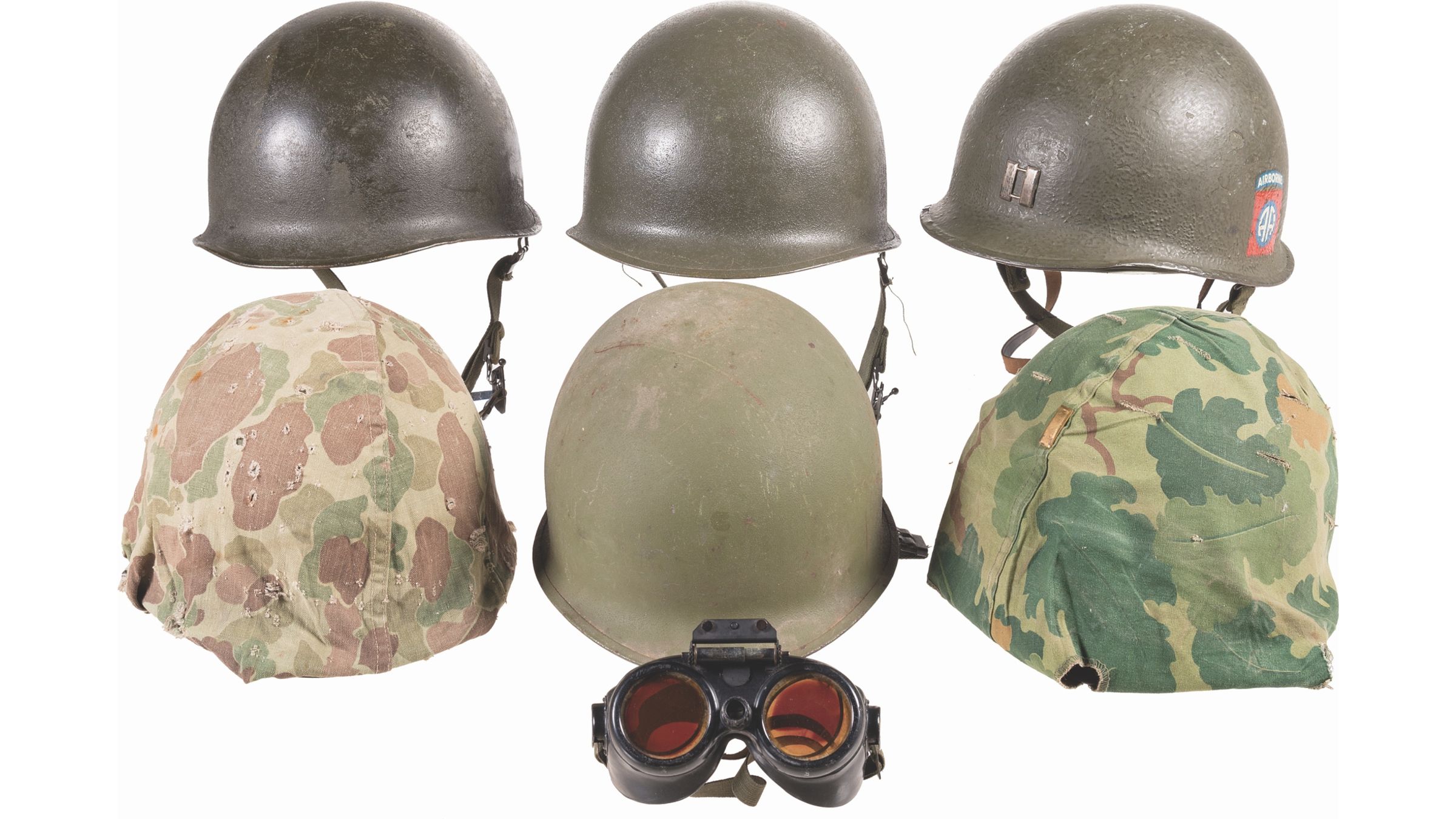 Six U.S. M1 Helmets and a Pair of Goggles | Rock Island Auction