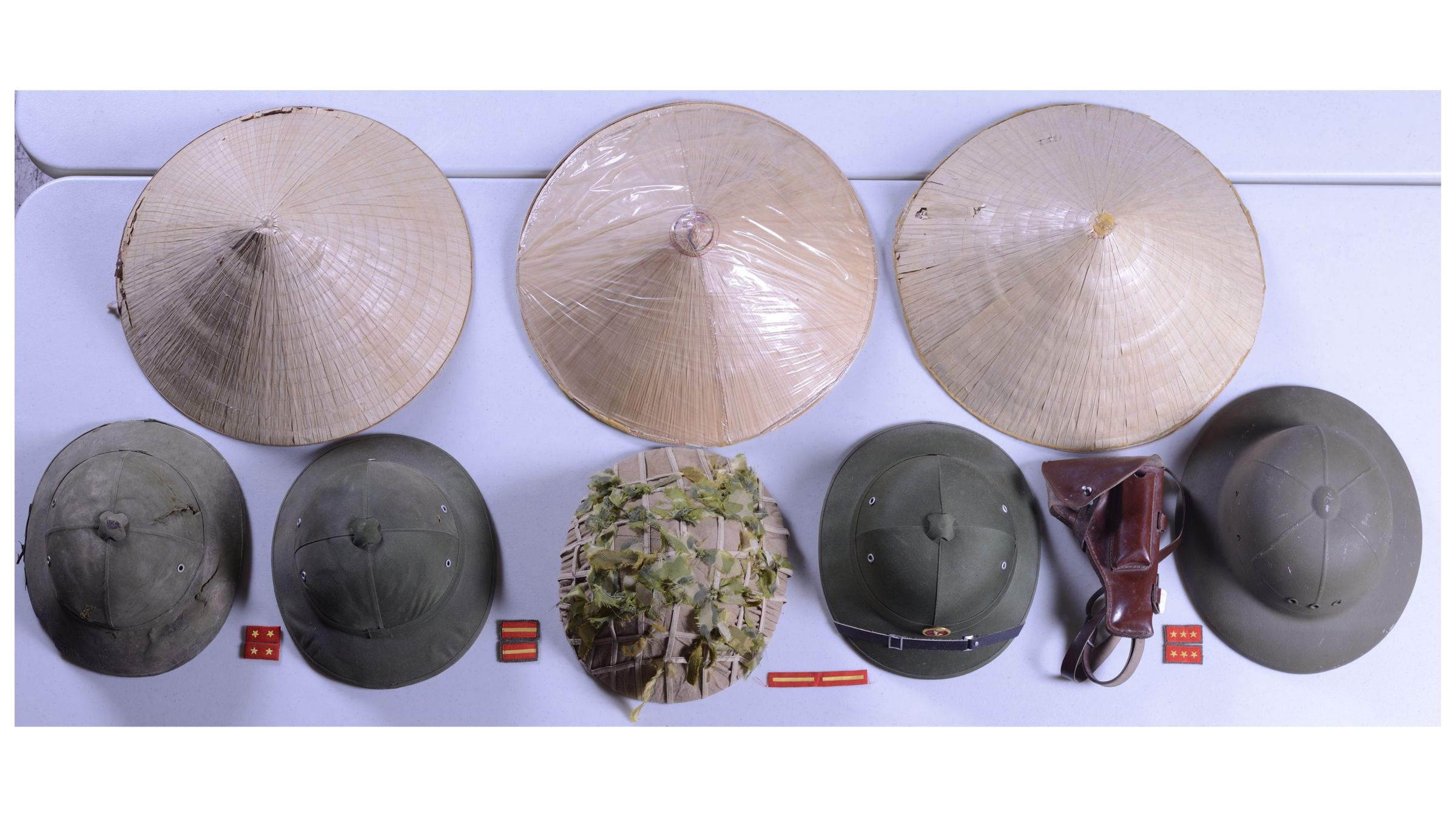 Group of North Vietnamese Helmets, Conical Hats, and a Holster | Rock ...