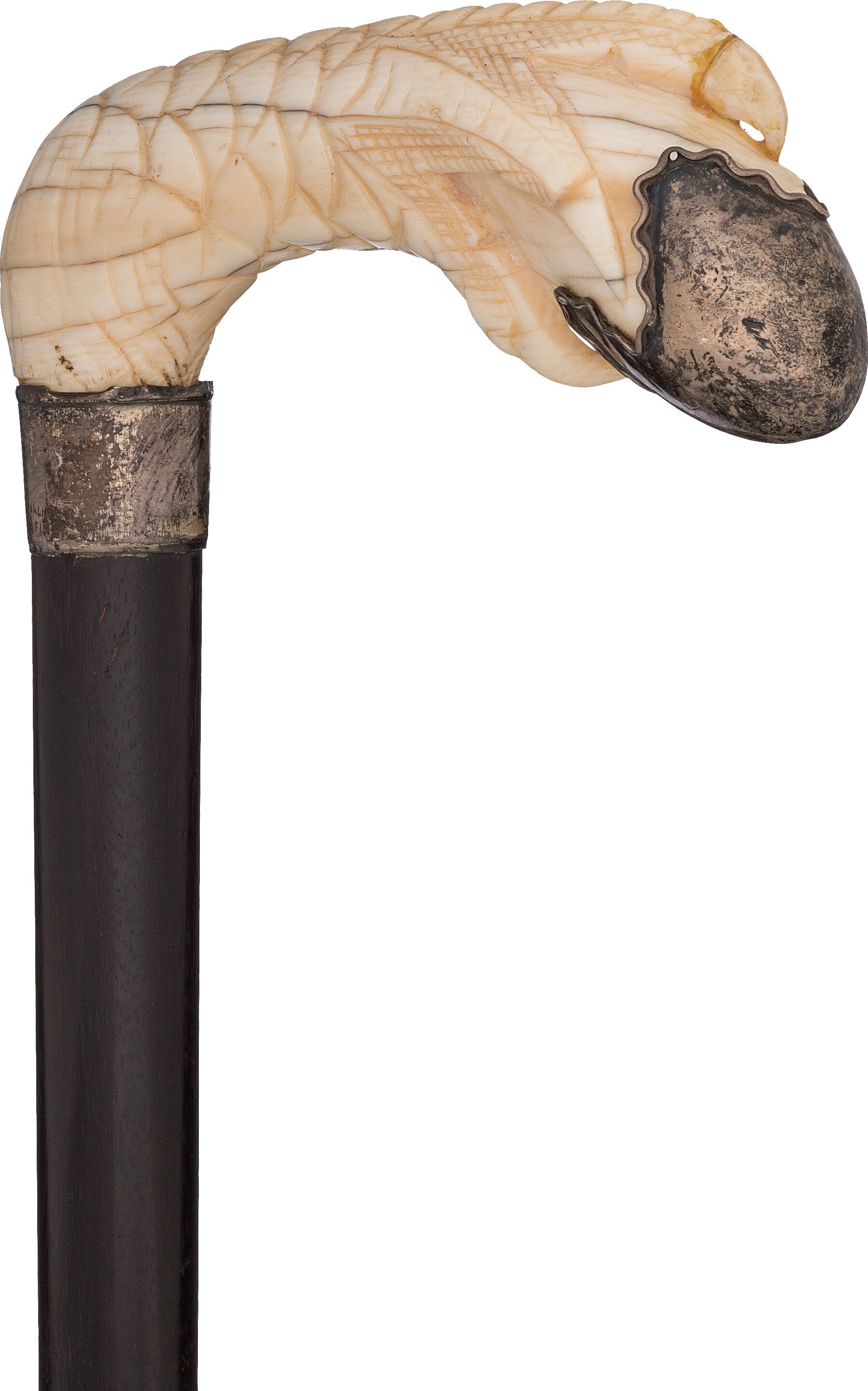 Relief Carved Eagle Talon Clutching an Egg Cane | Rock Island Auction